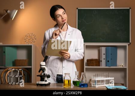 Female inventor with clipboard in laboratory Stock Photo - Alamy