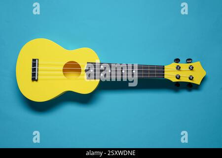 One ukulele on light blue background, top view Stock Photo - Alamy