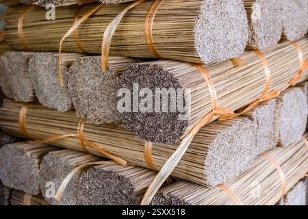 Stacked bundles of split thin bamboo sticks for the later production of ...