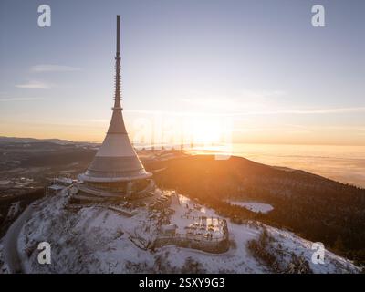 Early morning light illuminates Jested Mountain, covered in snow ...