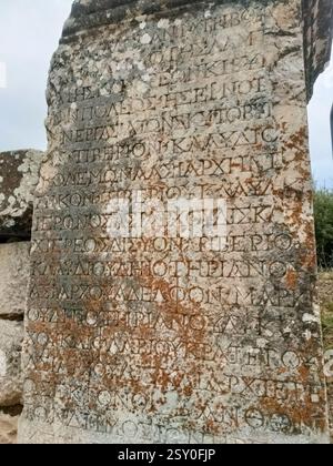Greek inscription on stone column base at the Slope Houses on Curetes ...