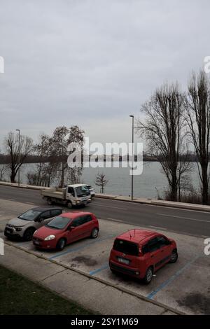 Mantova, Italy - 19TH FEBRUARY 2025 - Panoramic road with parked cars ...