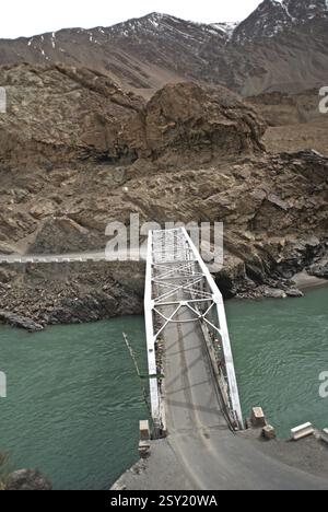 Aerial view of Indus River, bridge, and mountain range in tranquil ...