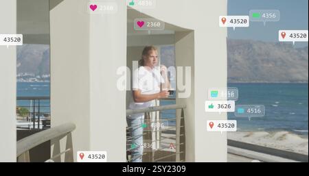 Digital icons and man with cup of coffee and mobile phone near window ...