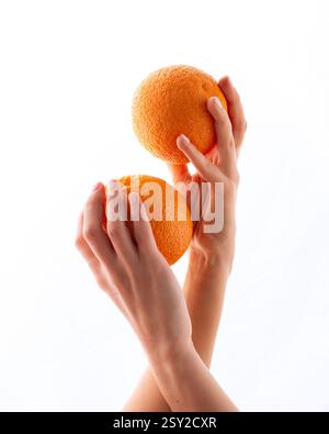 Female hands holding oranges. Illustration of orange-peel skin ...