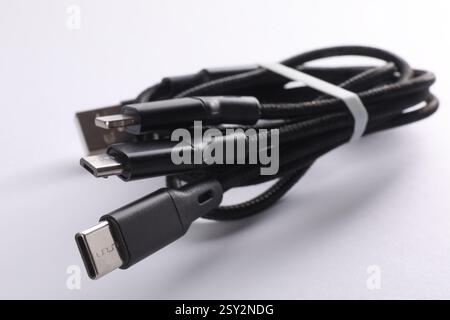 Black triple charge cable isolated on white Stock Photo - Alamy