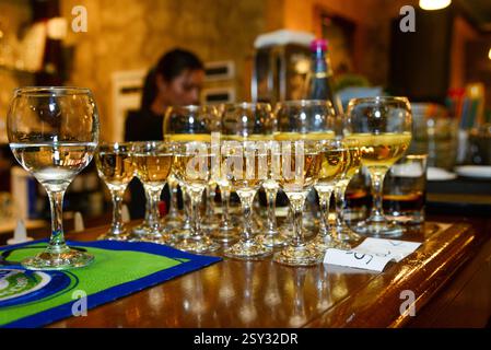 Glasses with various types of brandy are lined up on the bar as a pre ...