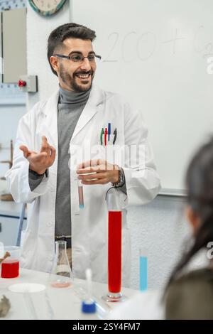 Young male chemistry teacher in front of periodic table Stock Photo - Alamy