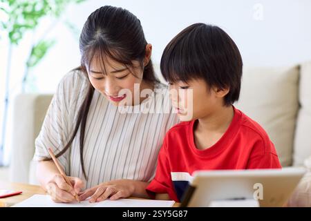 Japanese Mother And Son Doing Homework At Home Stock Photo - Alamy