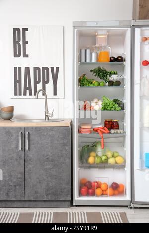 Open big fridge with fresh products in kitchen Stock Photo - Alamy