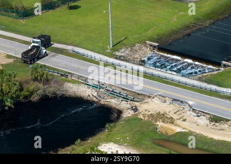 Construction trucks blocking road access at destroyed bridge after ...