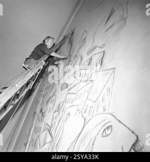 Romanian artist Mihu Vulcanescu (1937- 1994) working on a mural inside ...