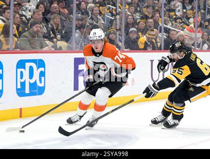 Philadelphia Flyers' Owen Tippett (74) battle for the puck with ...