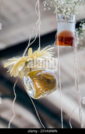 Herbal tea bottle with flowers hanging on string Stock Photo - Alamy