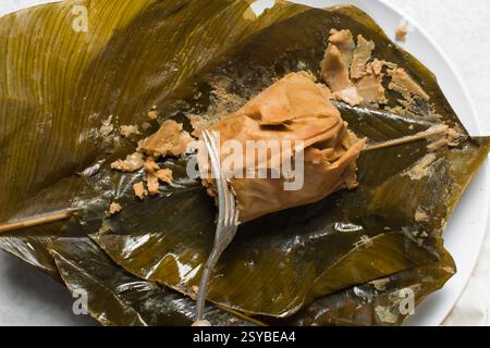 Overhead of moi moi in leaf on a plate, top view of nigerian bean ...