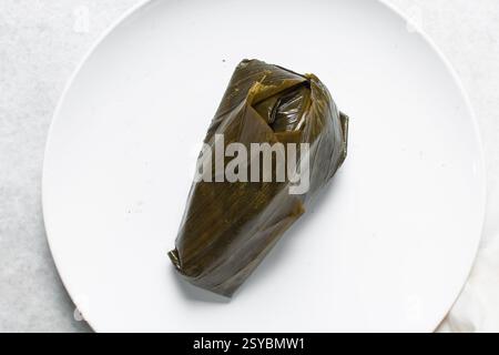 Overhead of moi moi in leaf on a plate, top view of nigerian bean ...