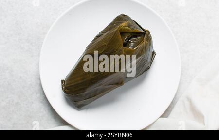 Overhead of moi moi in leaf on a plate, top view of nigerian bean ...