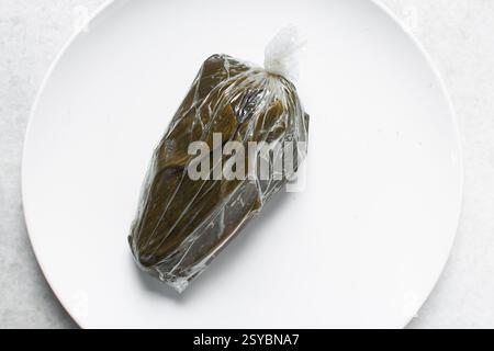 Overhead of moi moi in leaf on a plate, top view of nigerian bean ...
