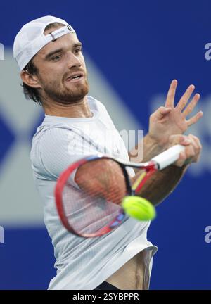 Learner Tien of the United States hits a forehand on his way to being ...
