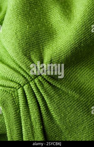 Close-up of an olive green fabric garment with a buttoned pocket Stock ...