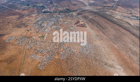 aerial cityscape with township in desert, shot from a glider plane in ...