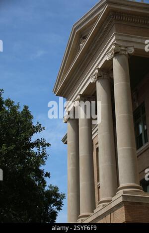 The entrance to a courthouse with tall ionic columns and courthouse ...
