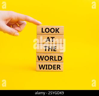 Look at the world wider symbol. Wooden blocks with words Look at the ...