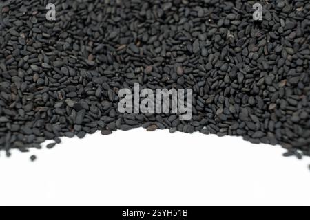 Black sesame seeds scattered on a white background place for text Stock ...