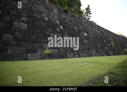 The imposing stone walls of the Imperial Palace in Tokyo stand as ...