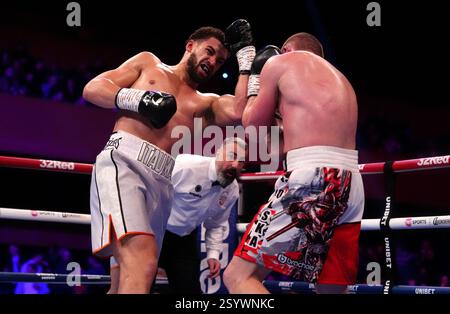 Karol Itauma (left) in action against Michal Ludwiczak in the light ...