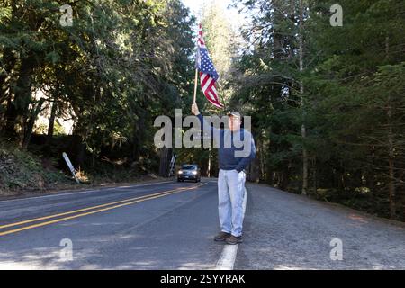 A protester holds and national flag upside down, Monday, June 9, 2025 ...