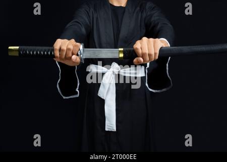 Samurai warrior gripping the sword with a black background Stock Photo ...