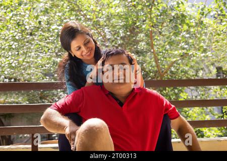 Woman giving head message to her husband on balcony Stock Photo - Alamy