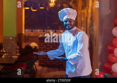 Male chef welcoming guest at restaurant Stock Photo - Alamy