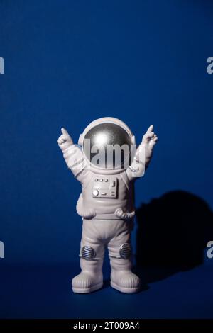 Plastic toy astronaut on colorful red background Copy space. Concept of ...