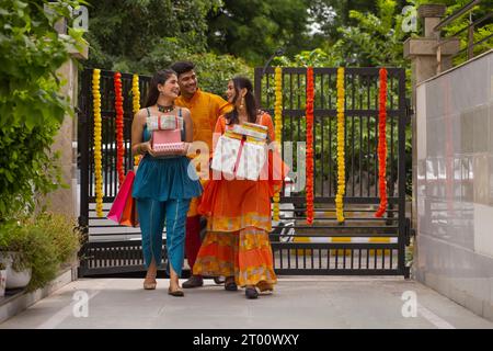 Brother and sisters carrying Diwali gifts after shopping Stock Photo ...