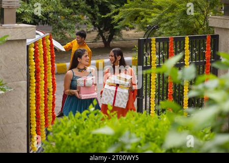Brother and sisters carrying Diwali gifts after shopping Stock Photo ...