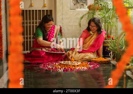 Mother-in-law and daughter-in-law decorating house with flowers and ...