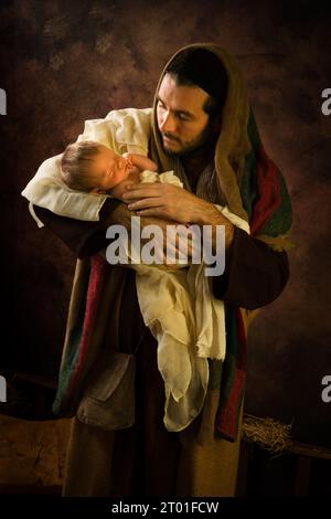 Proud Daddy playing Father Joseph with his own 8 days old son in a ...