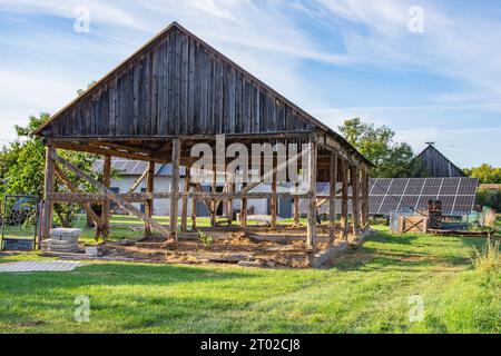 The skeleton of an old, destroyed barn being demolished on a sunny day ...