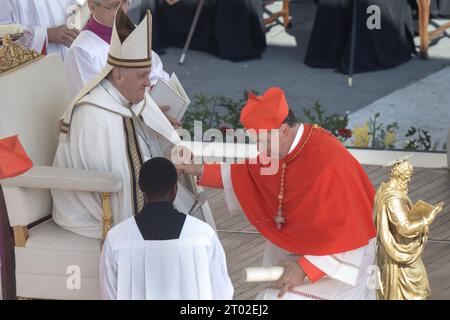 New cardinal Angel Fernandez Artime walks past Pope Francis during a ...