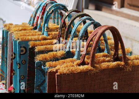 A row of quirky, unique, silky embroidered, multi coloured, Tote or ...