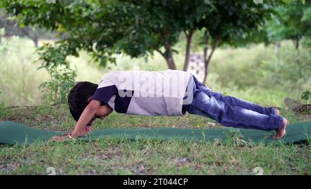 Young attractive boy exercising, Indian boy practicing meditation ...