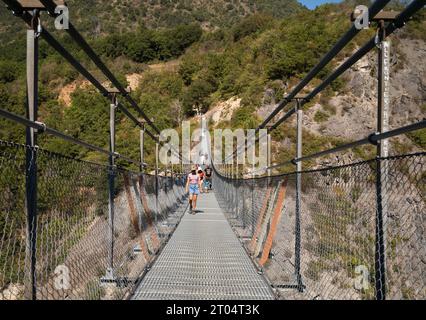 People cross the Passerelle du Drac (Drac Footbridge) over Lake ...