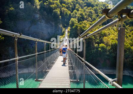 People cross the Passerelle du Drac (Drac Footbridge) over Lake ...