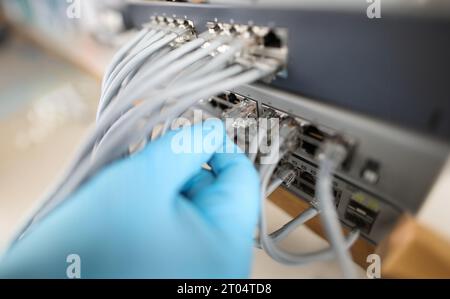 Hand of IT engineer technician with lot of internet network cable in ...