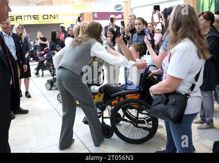The Princess of Wales hugs a well-wisher in a wheelchair during a visit ...