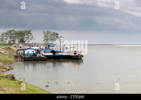 Small wooden ships docked in a small port on Brahmaputra river in Assam ...