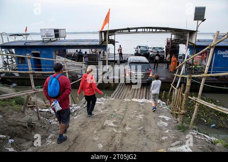 Car driving onto small ferry boat crossing Brahmaputra River to Majuli ...