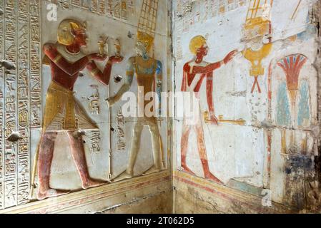 Colorful carved figures and symbols on the walls of the Temple of Seti ...